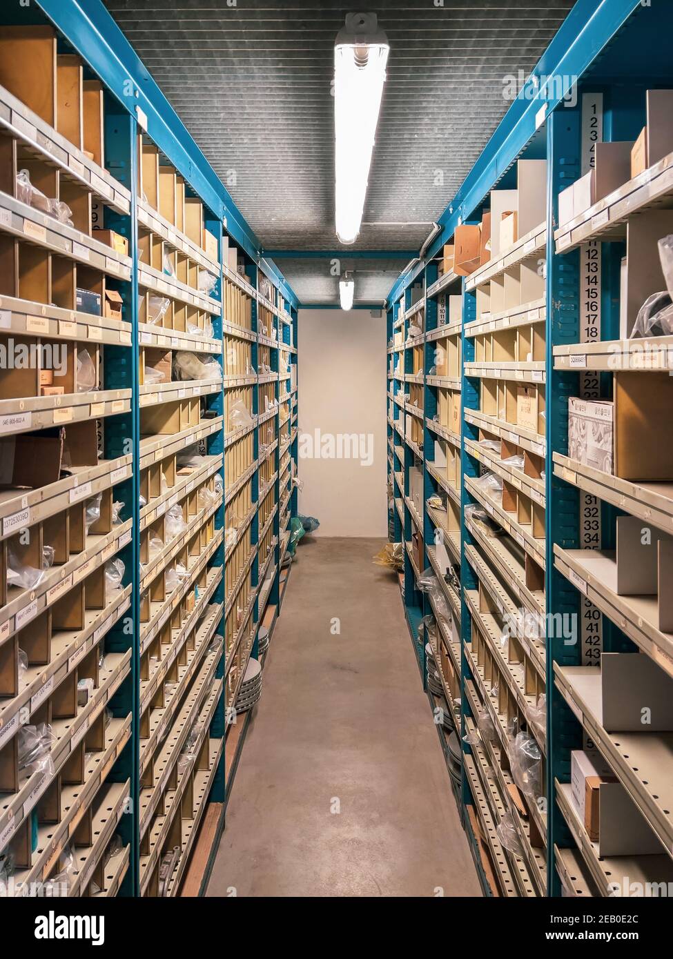 many shelves filled with spare parts stand in the parts store of the ...