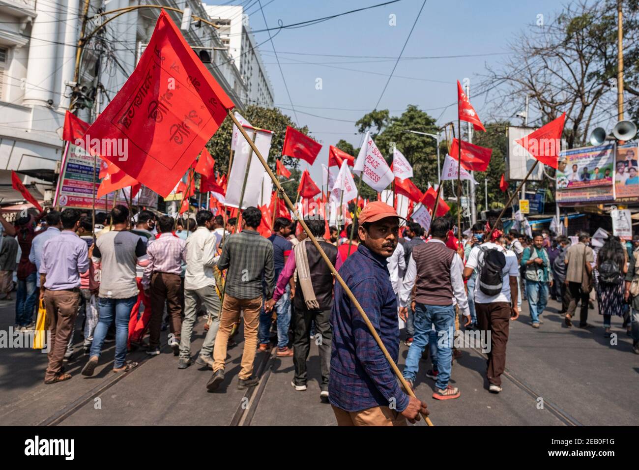 Activists hold flags while marching on the street during the ...