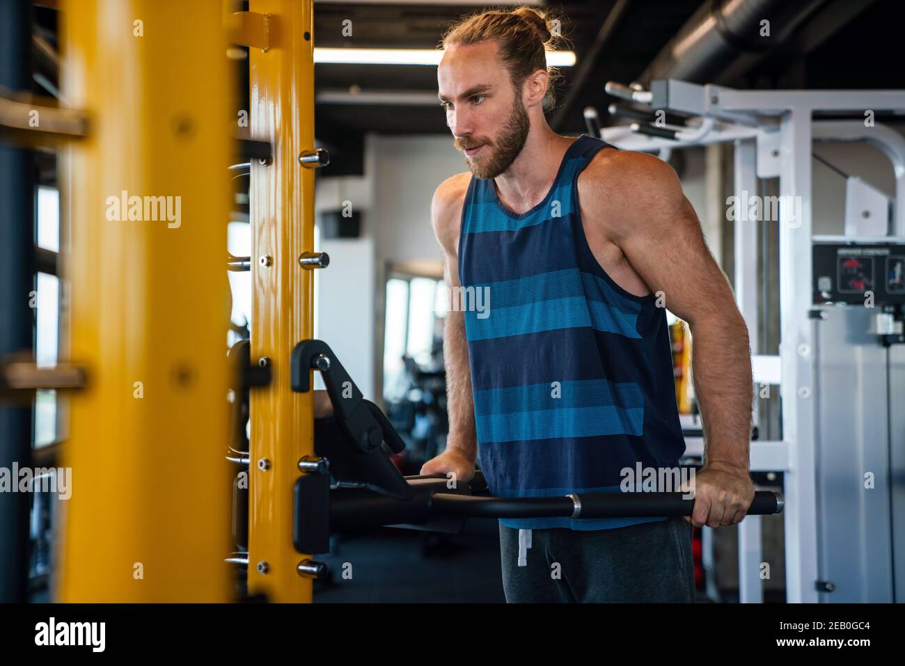 Muscular man working out in gym doing exercises to stay healthy Stock ...