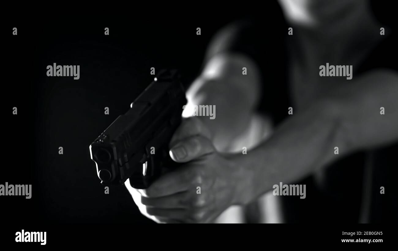 A woman's hands holding a pistol in a defensive position. Female self ...