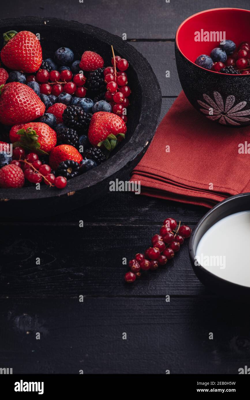 Healthy breakfast eating a mix of fresh berries fruits Stock Photo - Alamy