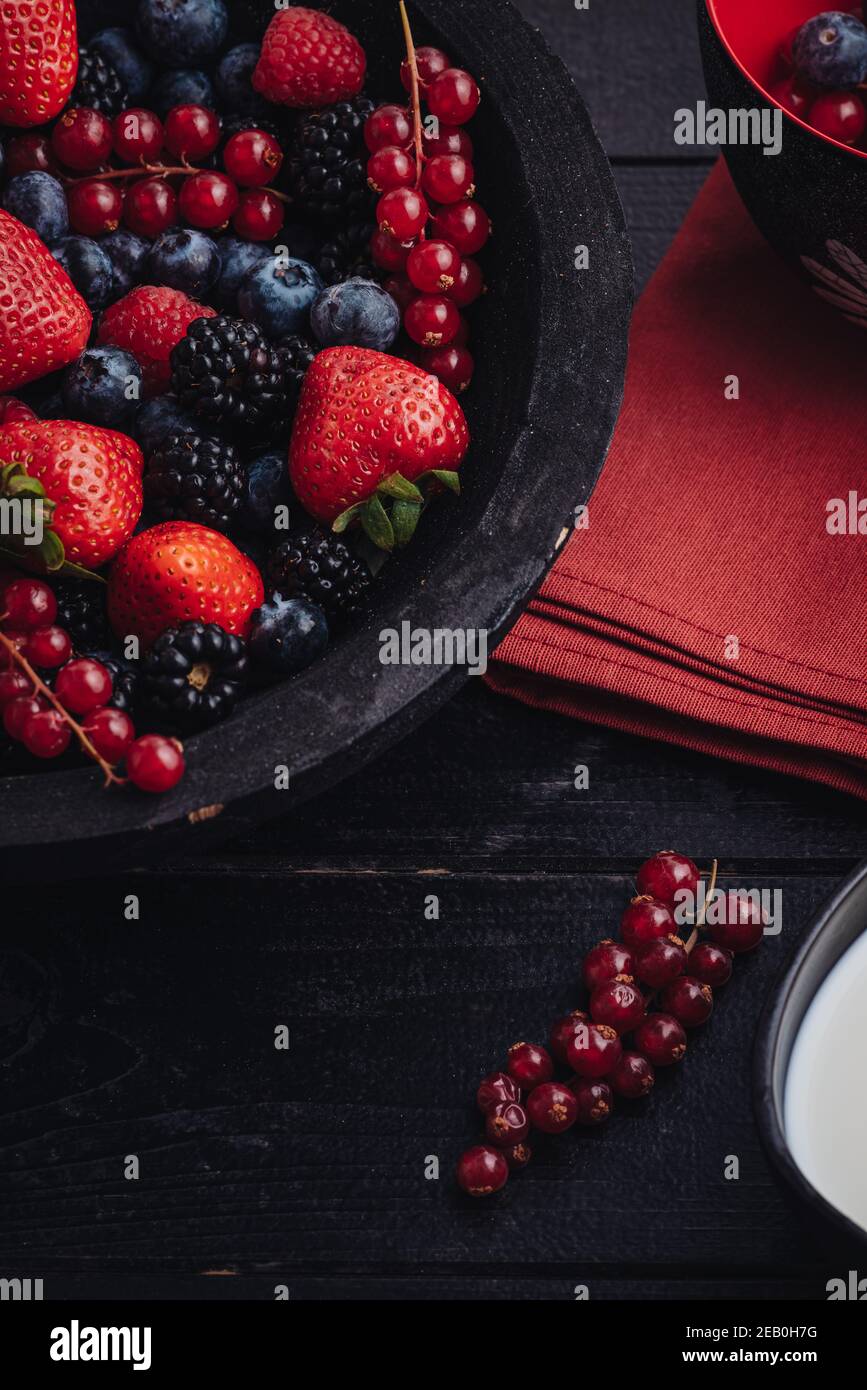 Healthy breakfast eating a mix of fresh berries fruits Stock Photo - Alamy