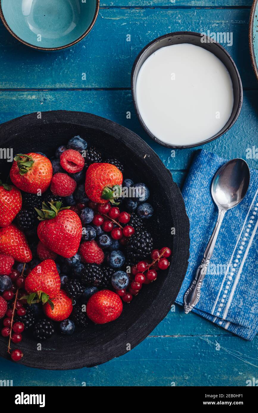 Healthy breakfast eating a mix of fresh berries fruits Stock Photo - Alamy