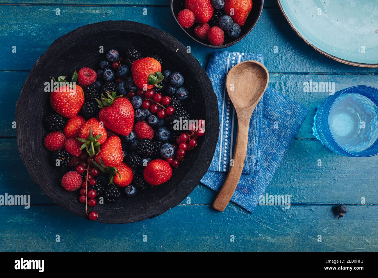 Healthy breakfast eating a mix of fresh berries fruits Stock Photo - Alamy