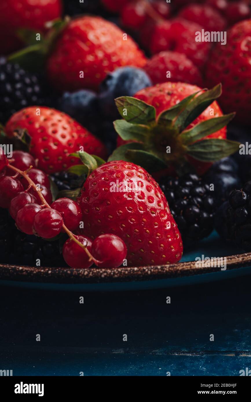 Healthy breakfast eating a mix of raw fresh berries fruits Stock Photo ...