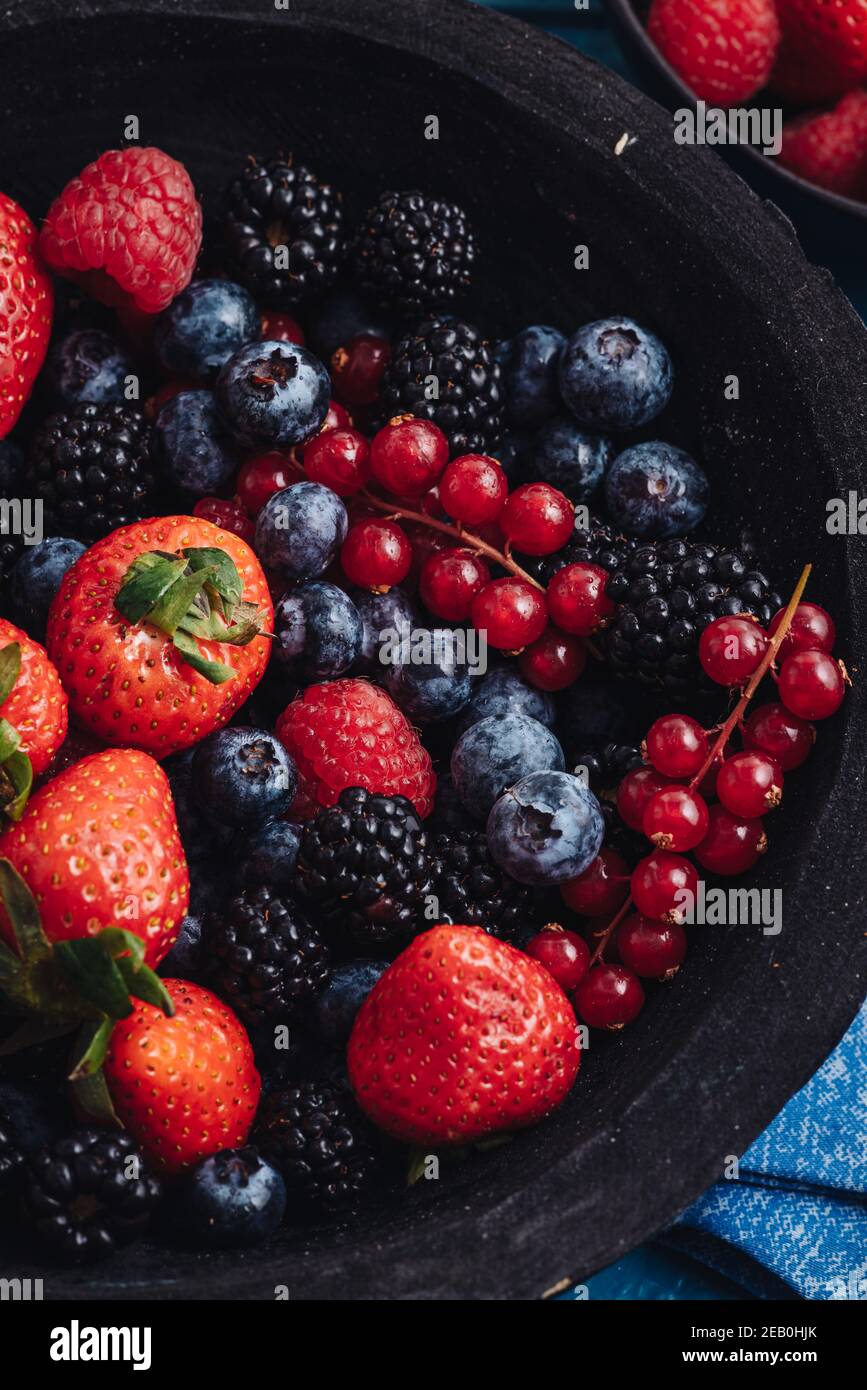 Healthy breakfast eating a mix of raw fresh berries fruits Stock Photo ...