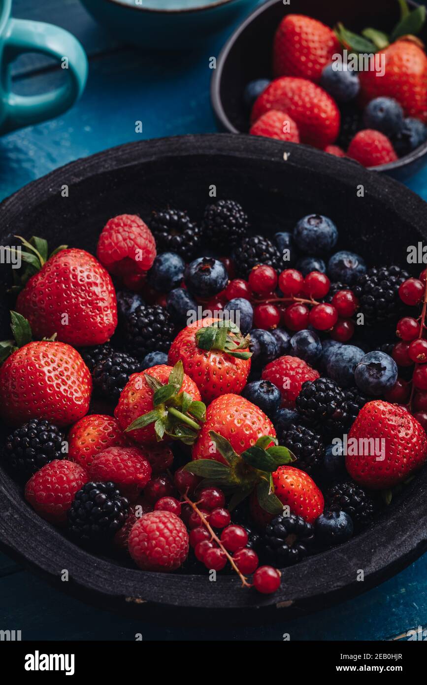 Healthy breakfast eating a mix of raw fresh berries fruits Stock Photo ...