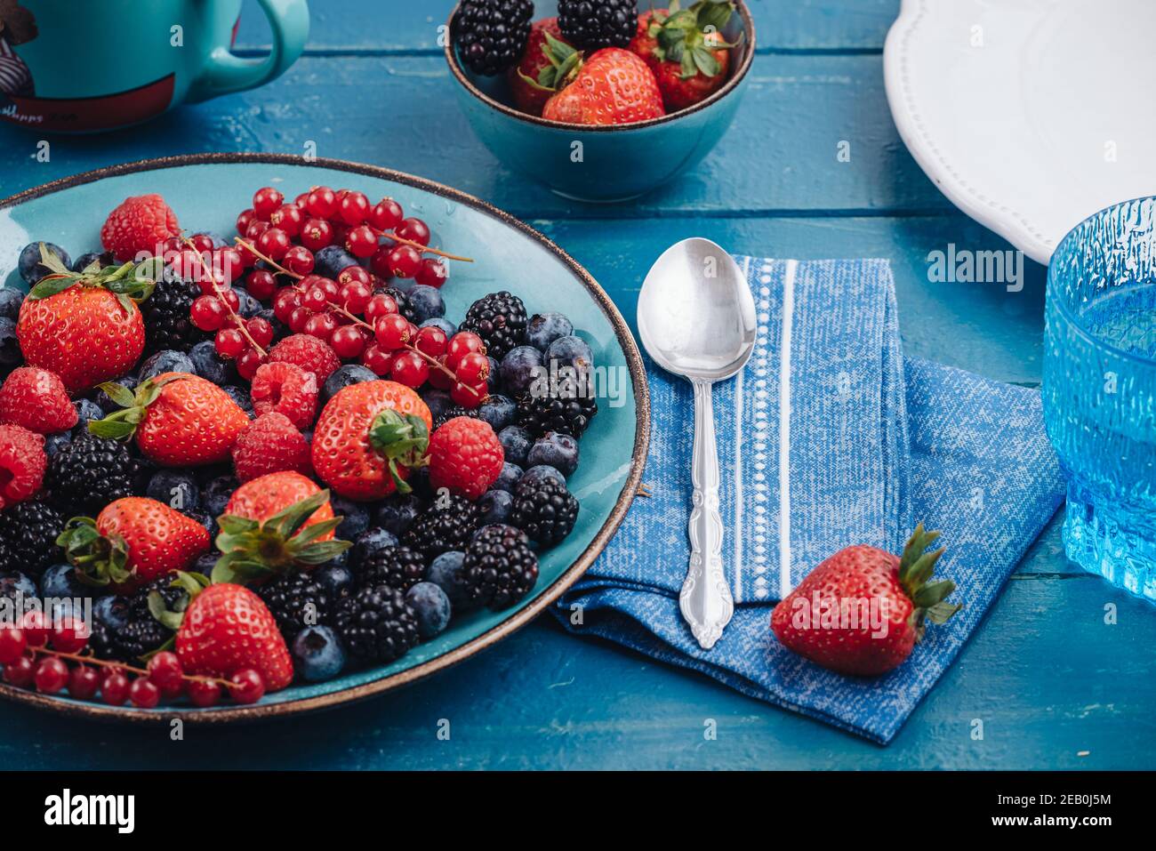 Healthy breakfast eating a mix of raw fresh berries fruits Stock Photo ...