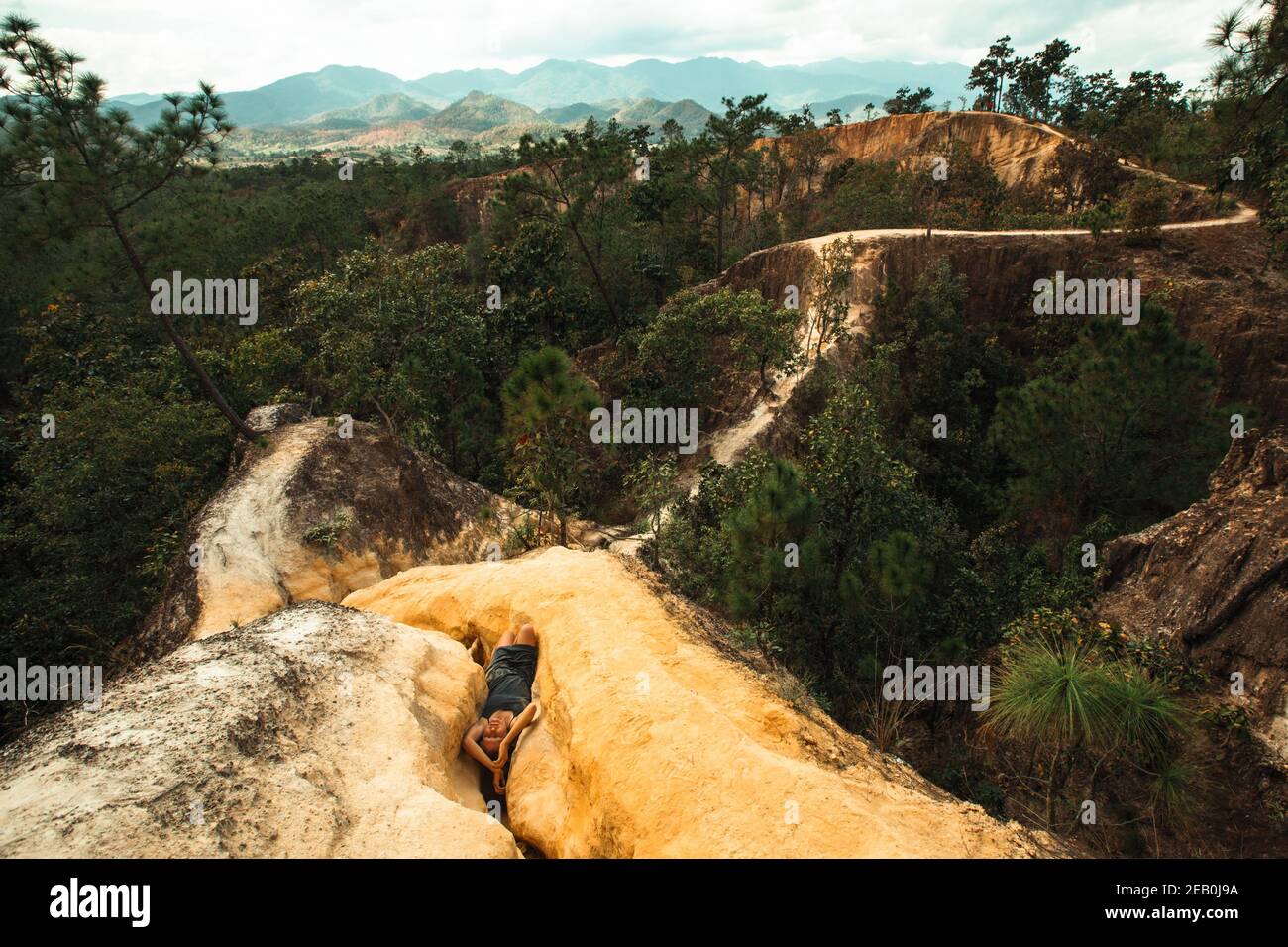 Young girl lying on the rocks in the canyon. Nord Thailand Stock Photo ...