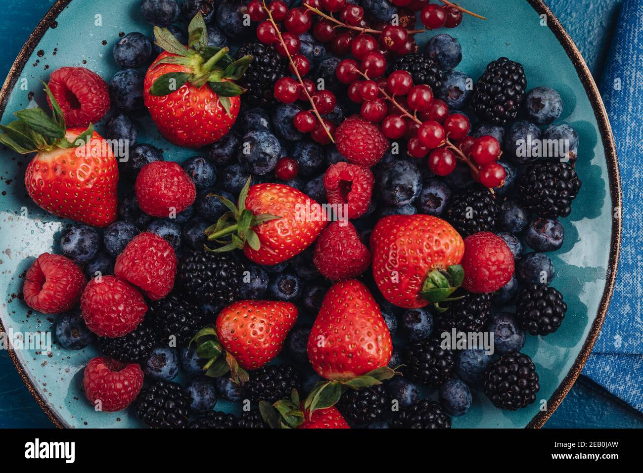 Healthy breakfast eating a mix of raw fresh berries fruits Stock Photo ...