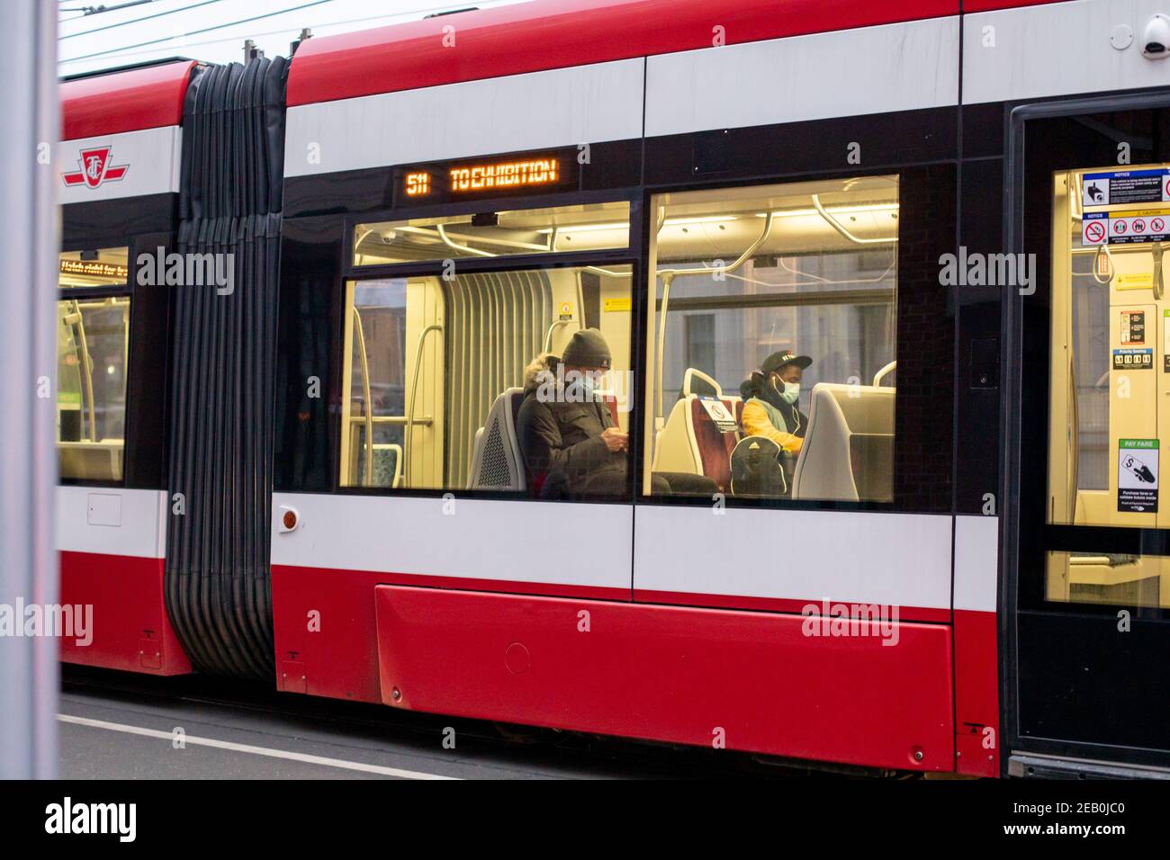 PEOPLE WEAR FACE MASKS ON TTC STREET CAR DURING COVID-19 PANDEMIC Stock ...