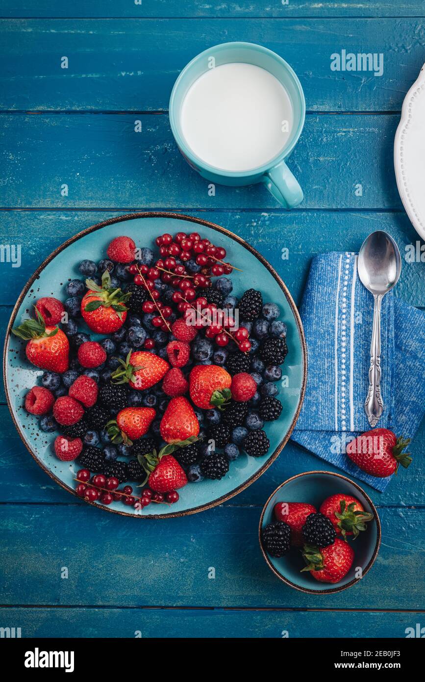 Healthy breakfast eating a mix of raw fresh berries fruits Stock Photo ...