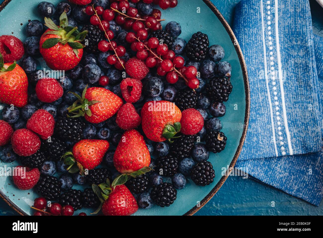 Healthy breakfast eating a mix of raw fresh berries fruits Stock Photo ...