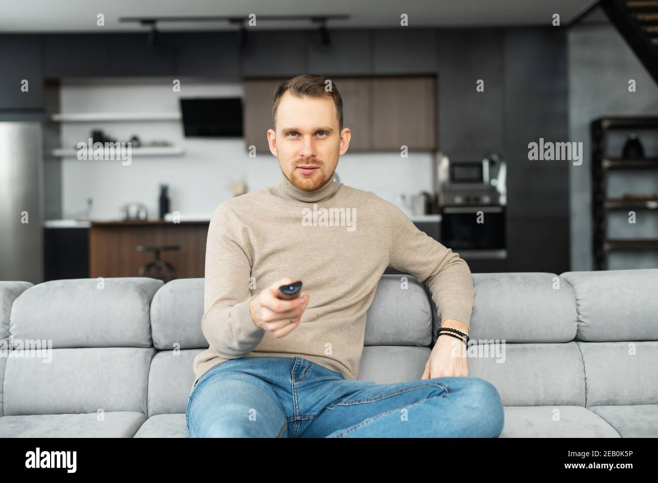 Man holding tv remote hi-res stock photography and images - Alamy