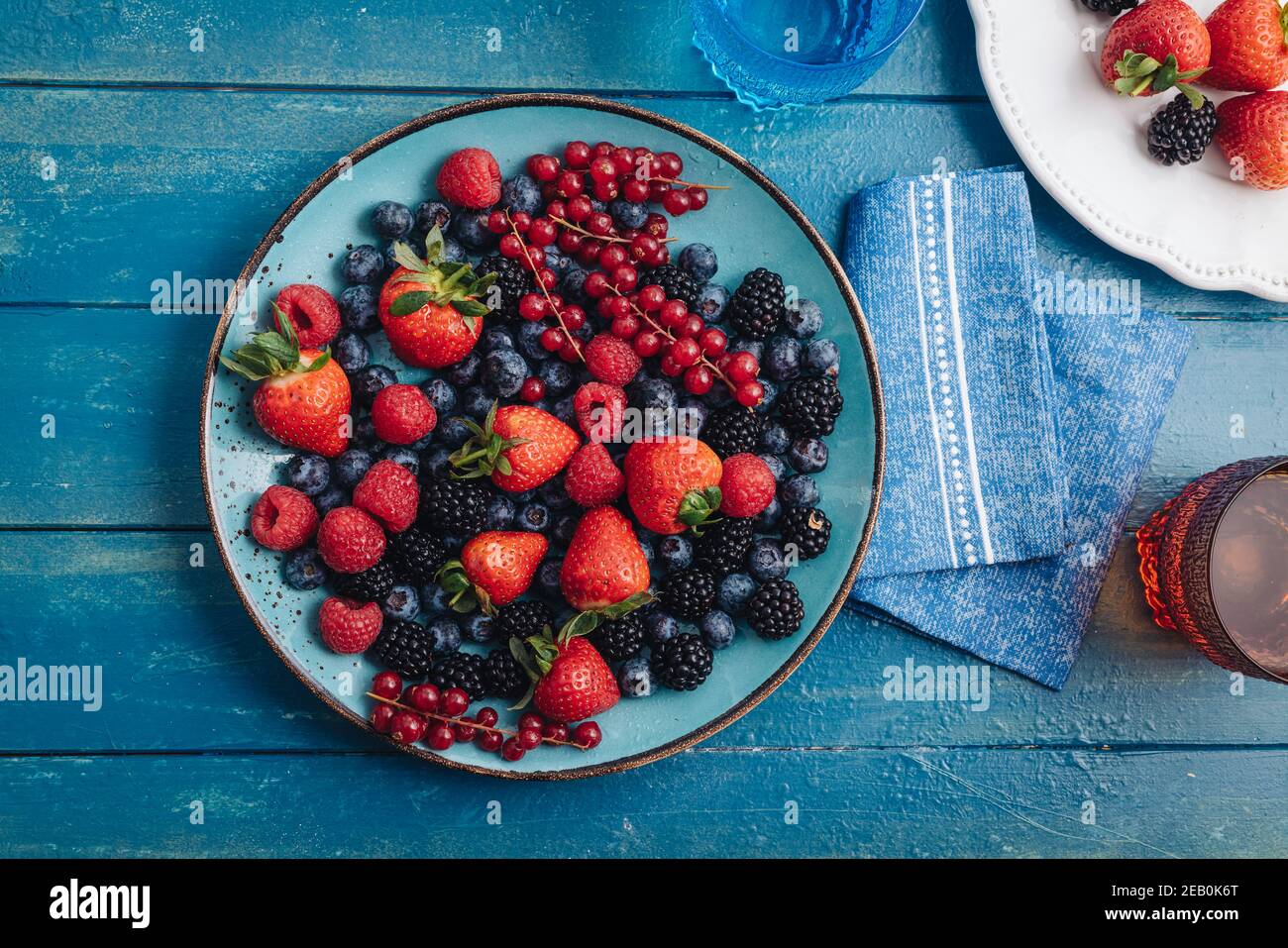 Healthy breakfast eating a mix of raw fresh berries fruits Stock Photo ...