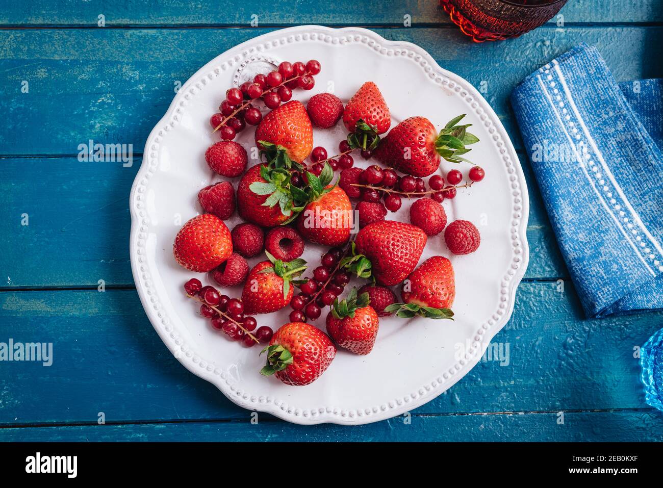 Healthy breakfast eating a mix of fresh red berries fruits Stock Photo ...