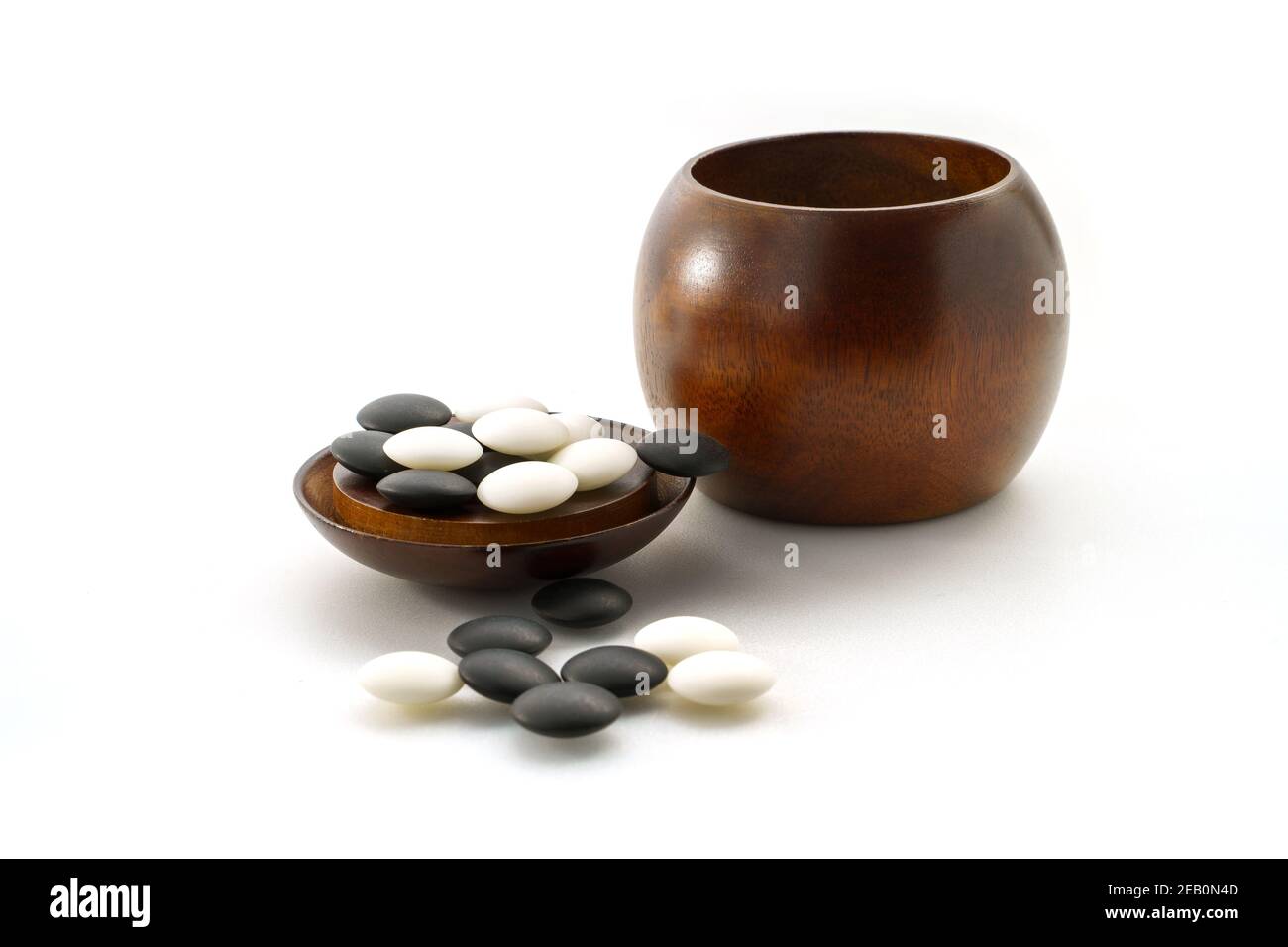 black and white stones of baduk game on wooden board isolated on white ...