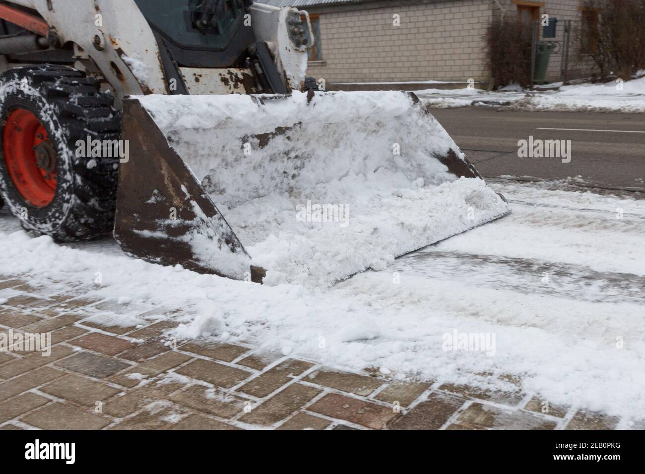 small excavator bobcat working on the street Stock Photo - Alamy