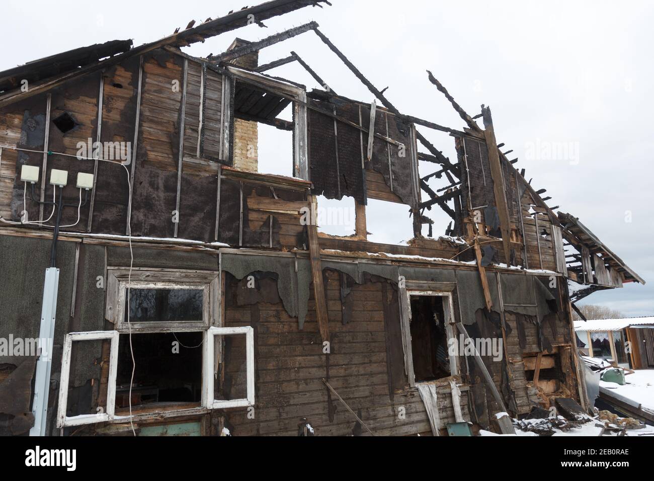 Burnt wooden house. House after the fire. Burned brick house with burnt ...