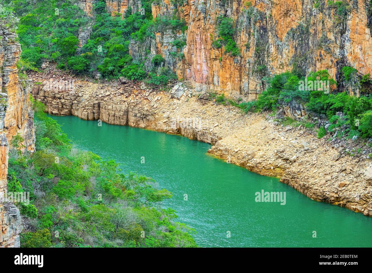 Lake with natural green water surrounded by sedimentary rocks on lake ...