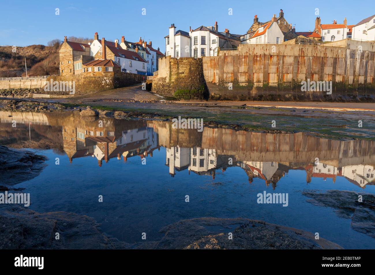 View of the boat landing and village of Robin Hood's Bay reflected in a ...