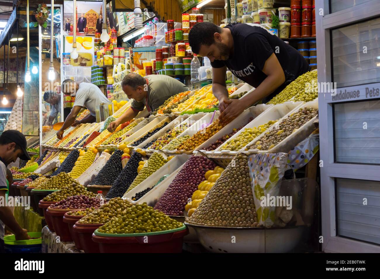 Shopkeepers arranging their display of olives in the indoors olive ...