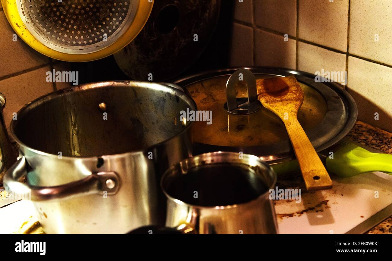 Dirty pans and pots in messy kitchen waiting to washing. Decay concept ...