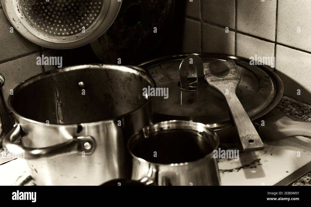 Dirty pans and pots in messy kitchen waiting to washing. Decay concept ...