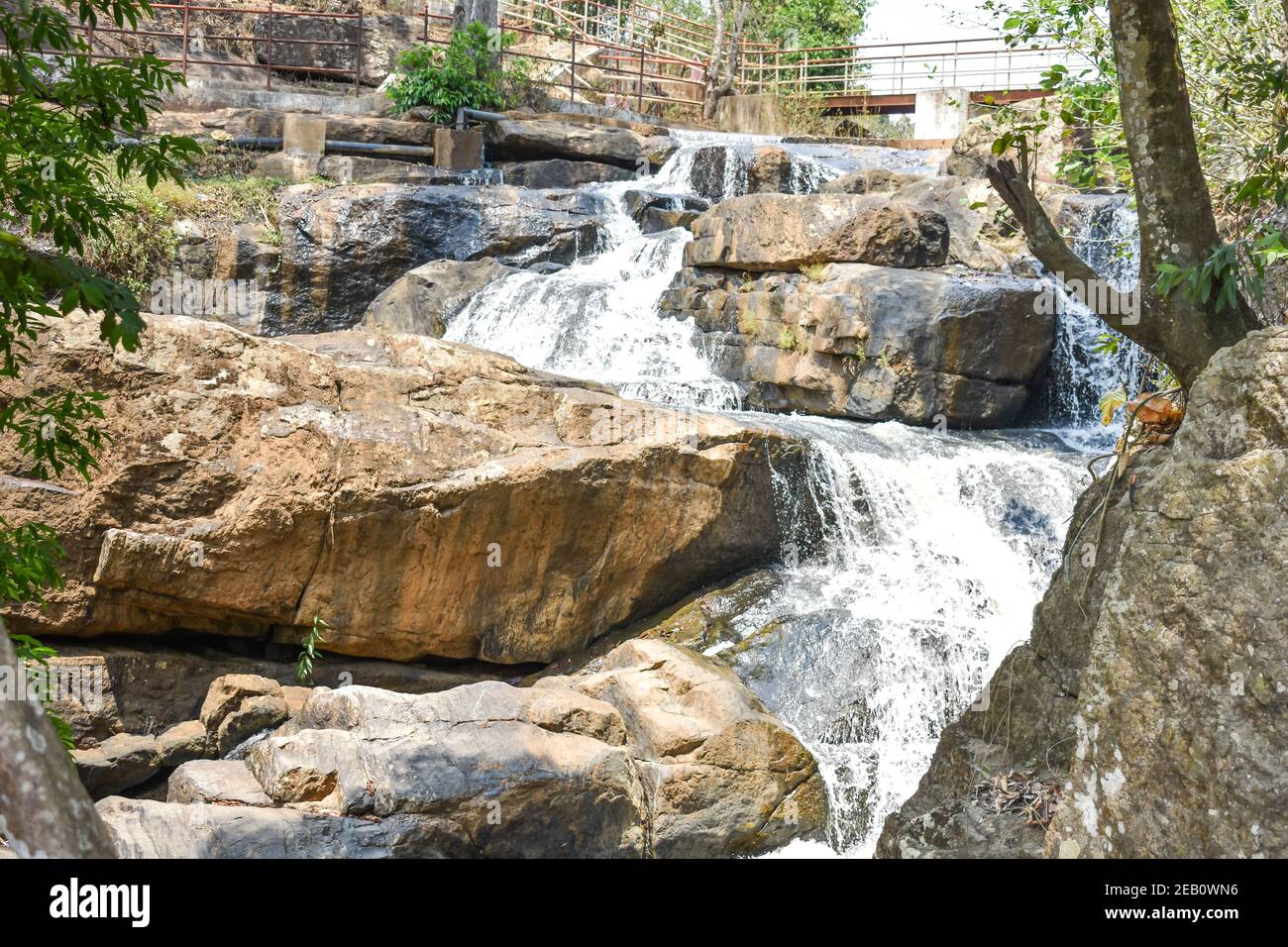 awesome view of waterfall passing through a mountain big rock near by ...