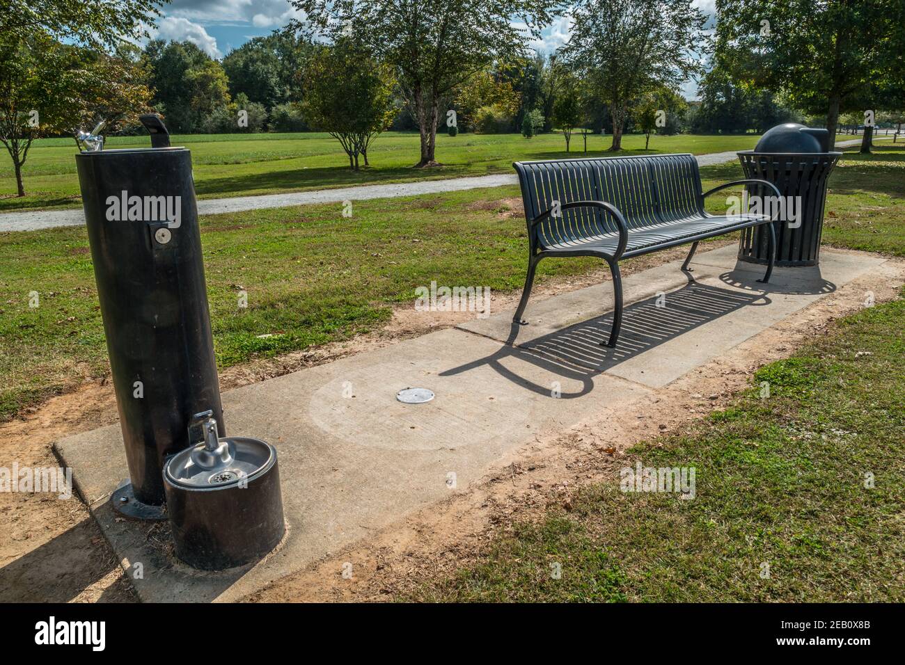 Must haves in a public park water fountain sitting bench and a garbage ...