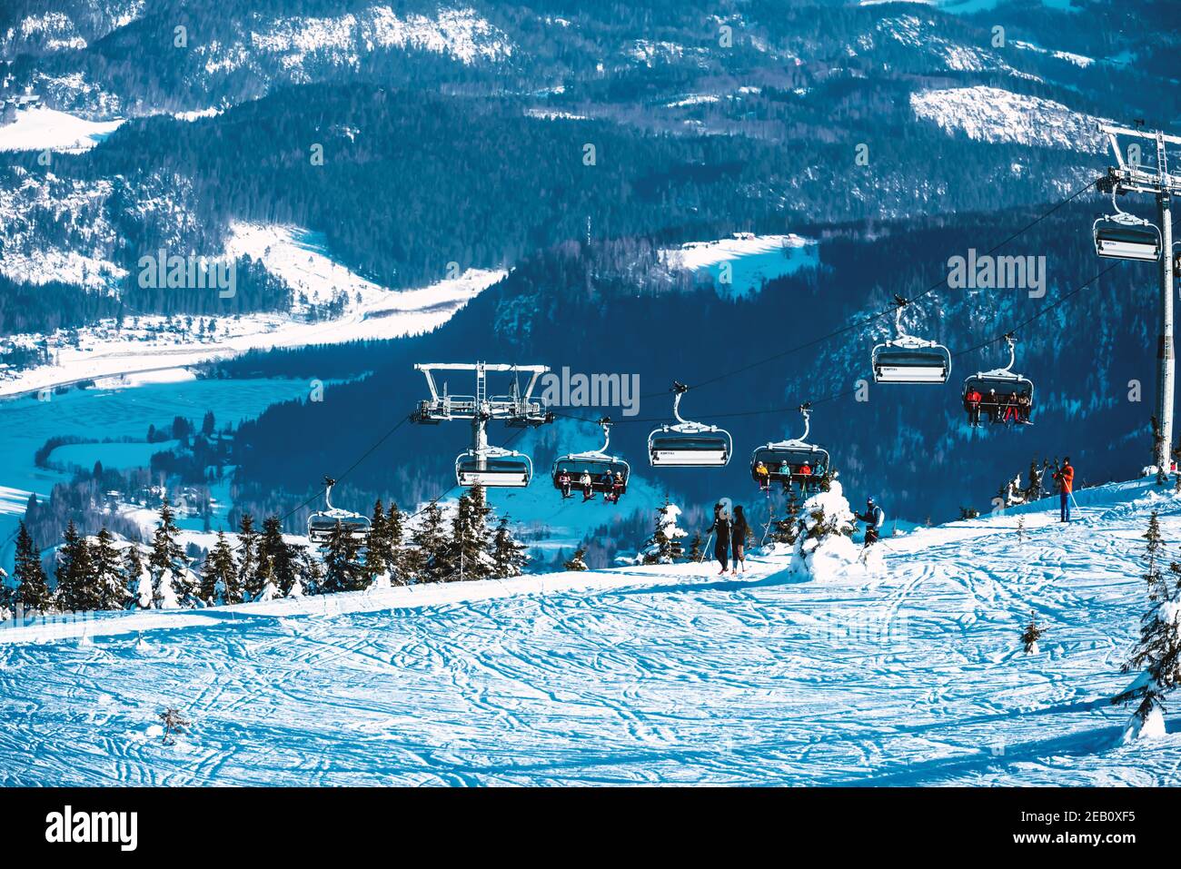 View over a ski resort with people in chair lifts Stock Photo - Alamy