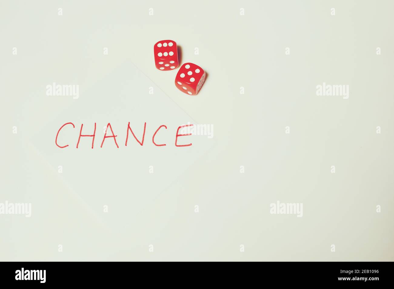 Concept of 2 red dice and the word chance written by hand with copy ...