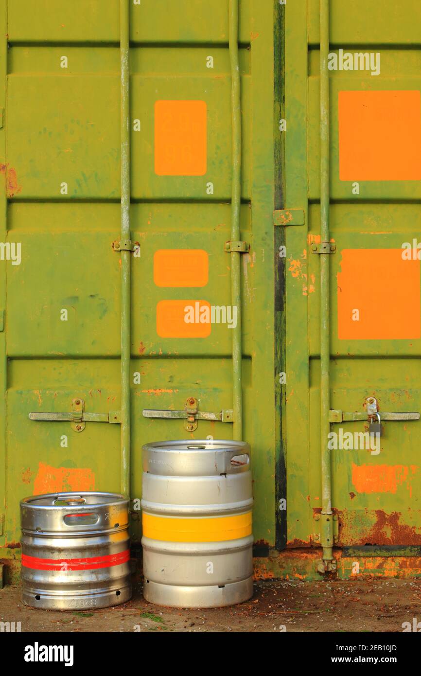 Colorful beer barrels next to metal container Stock Photo - Alamy