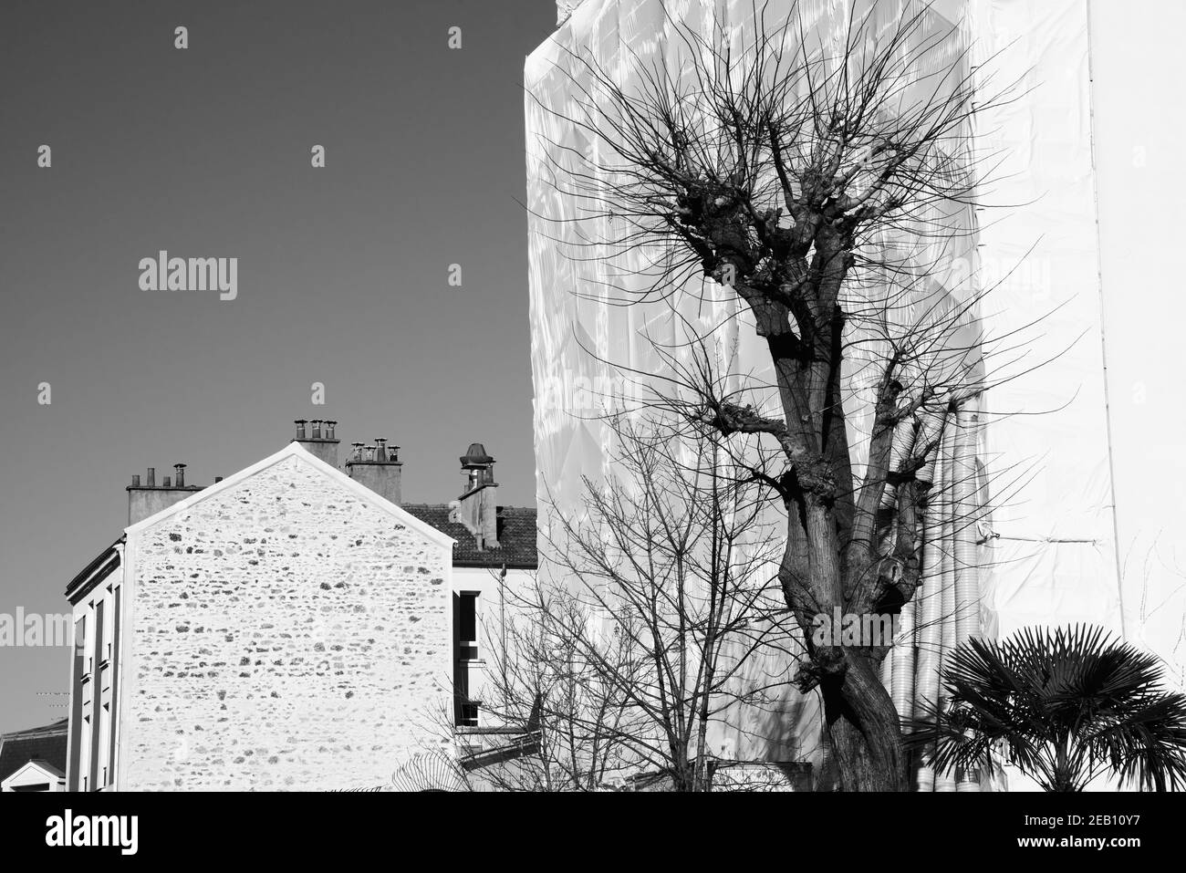 Renovation of residential building. House facade covered with plastic ...