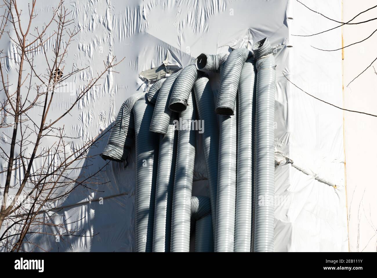 Renovation of residential building. House facade covered with plastic ...