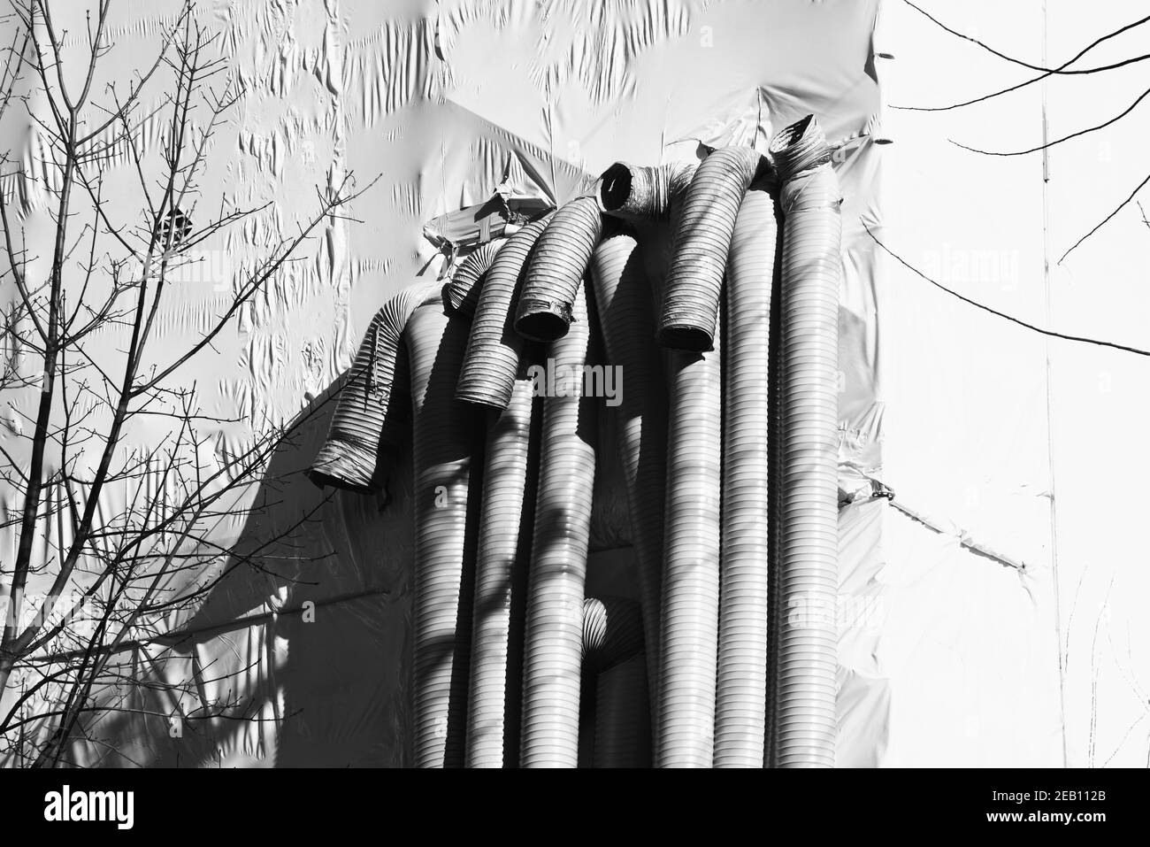 Renovation of residential building. House facade covered with plastic ...