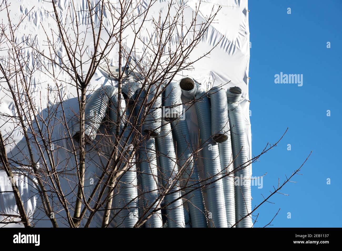 Renovation of residential building. House facade covered with plastic ...