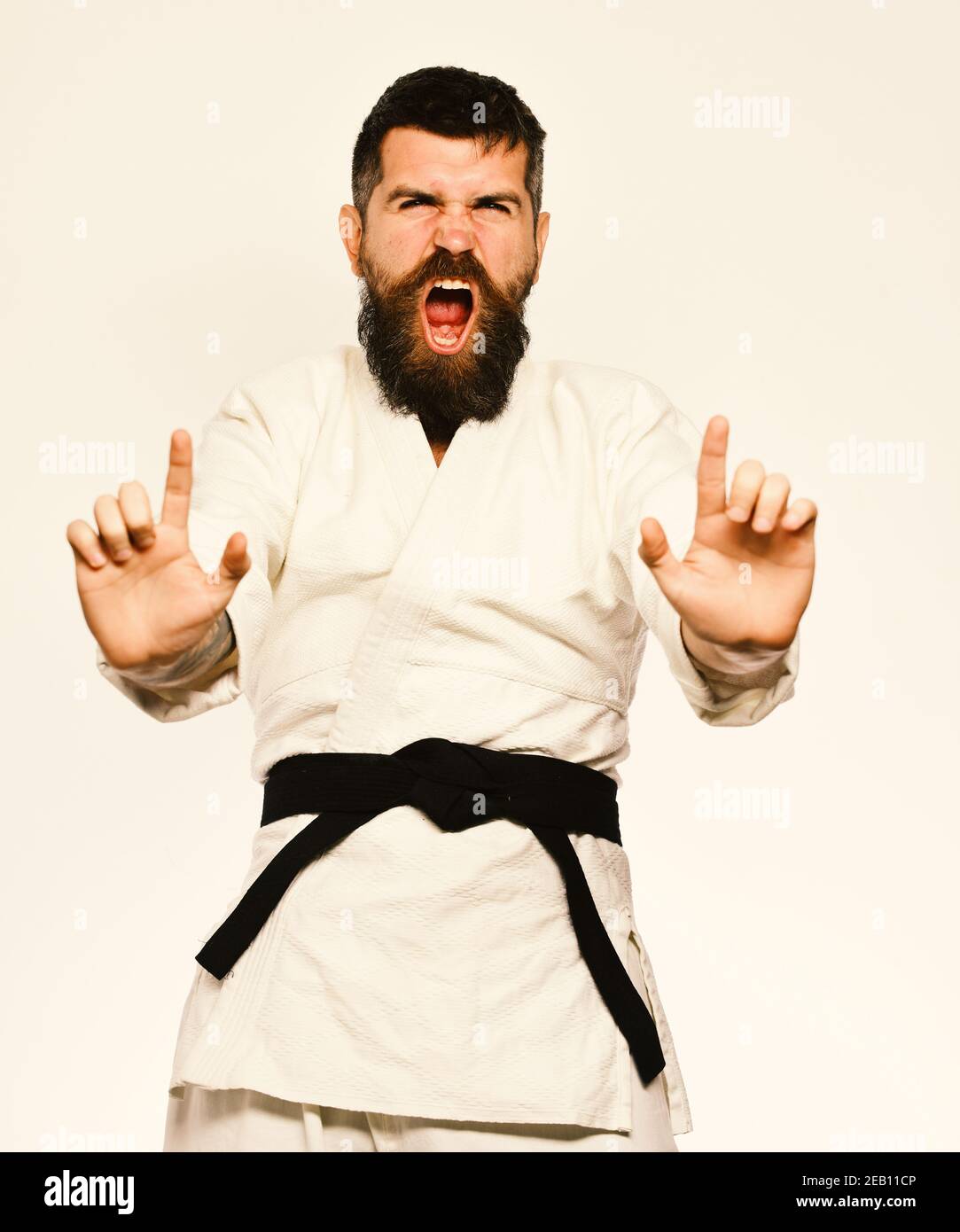 Karate man with angry face in uniform. Oriental sports concept. Jiu ...