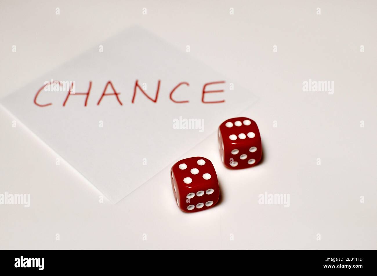 Concept of 2 red dice and the word chance written by hand with copy ...