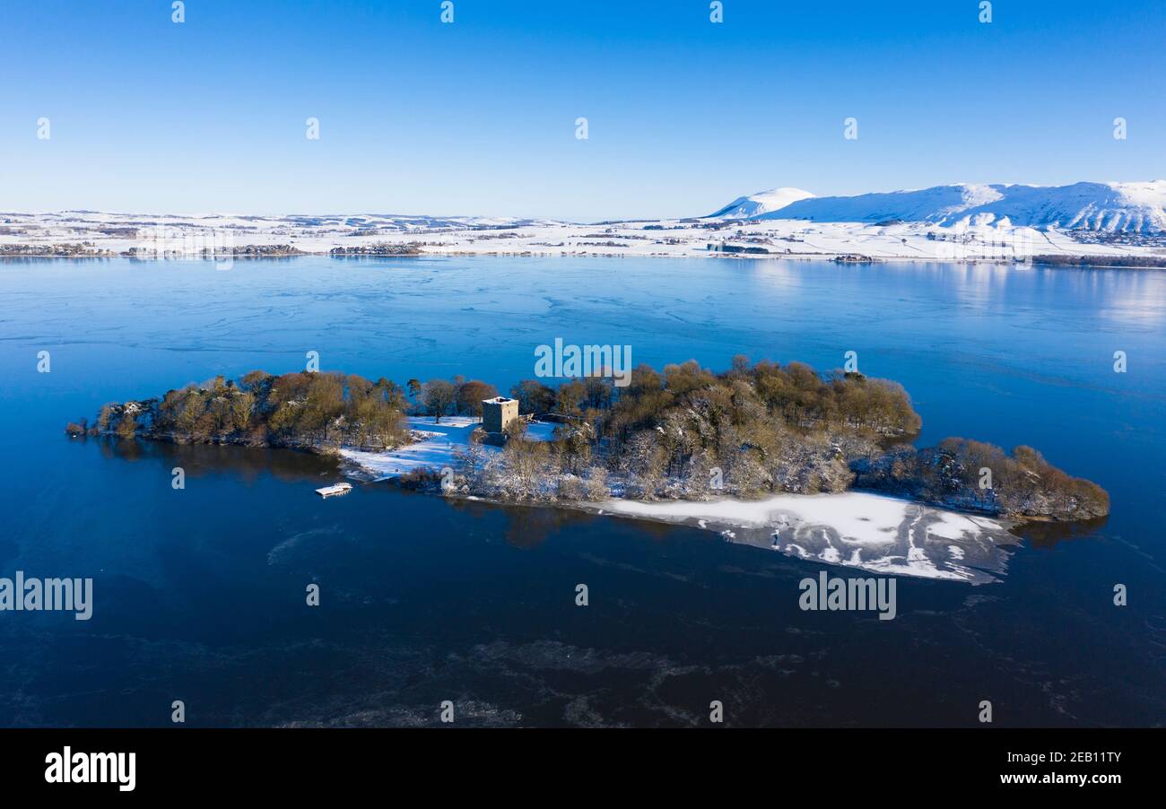 Kinross, Scotland, UK. Aerial view of a snow covered Lochleven Castle ...