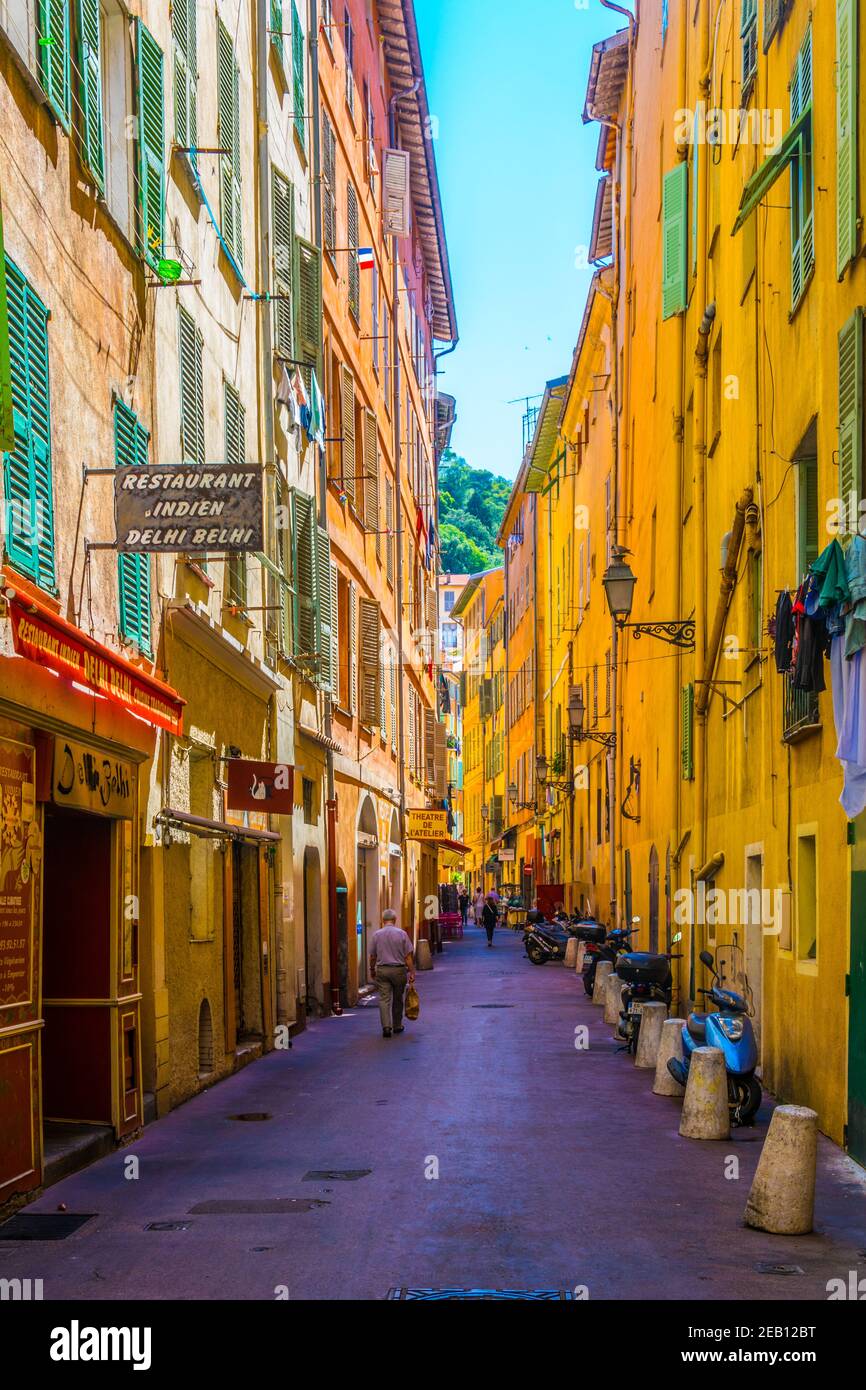 NICE, FRANCE, JUNE 11, 2017: People are strolling through a narrow ...