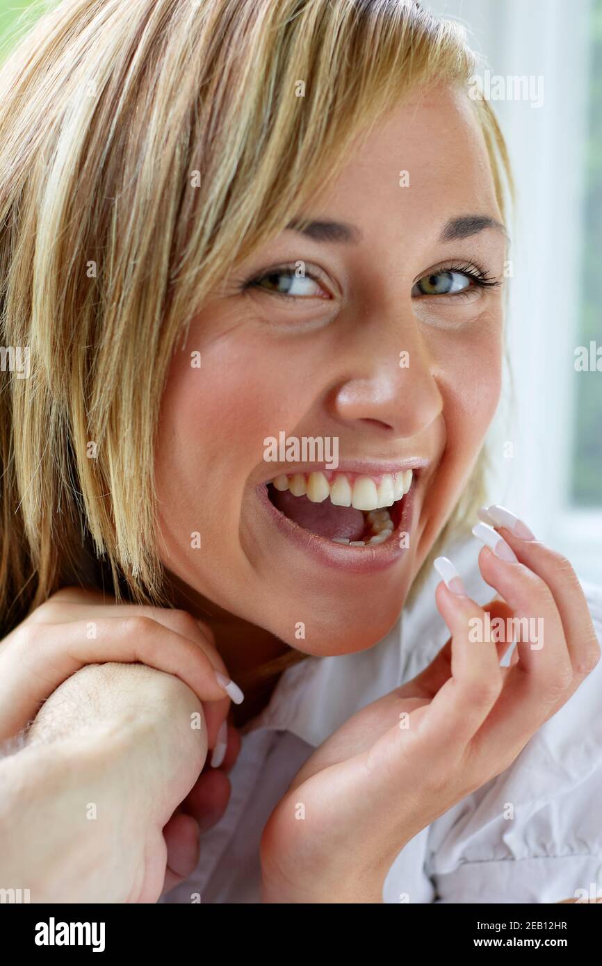 woman with her partners hands touching her face Stock Photo - Alamy