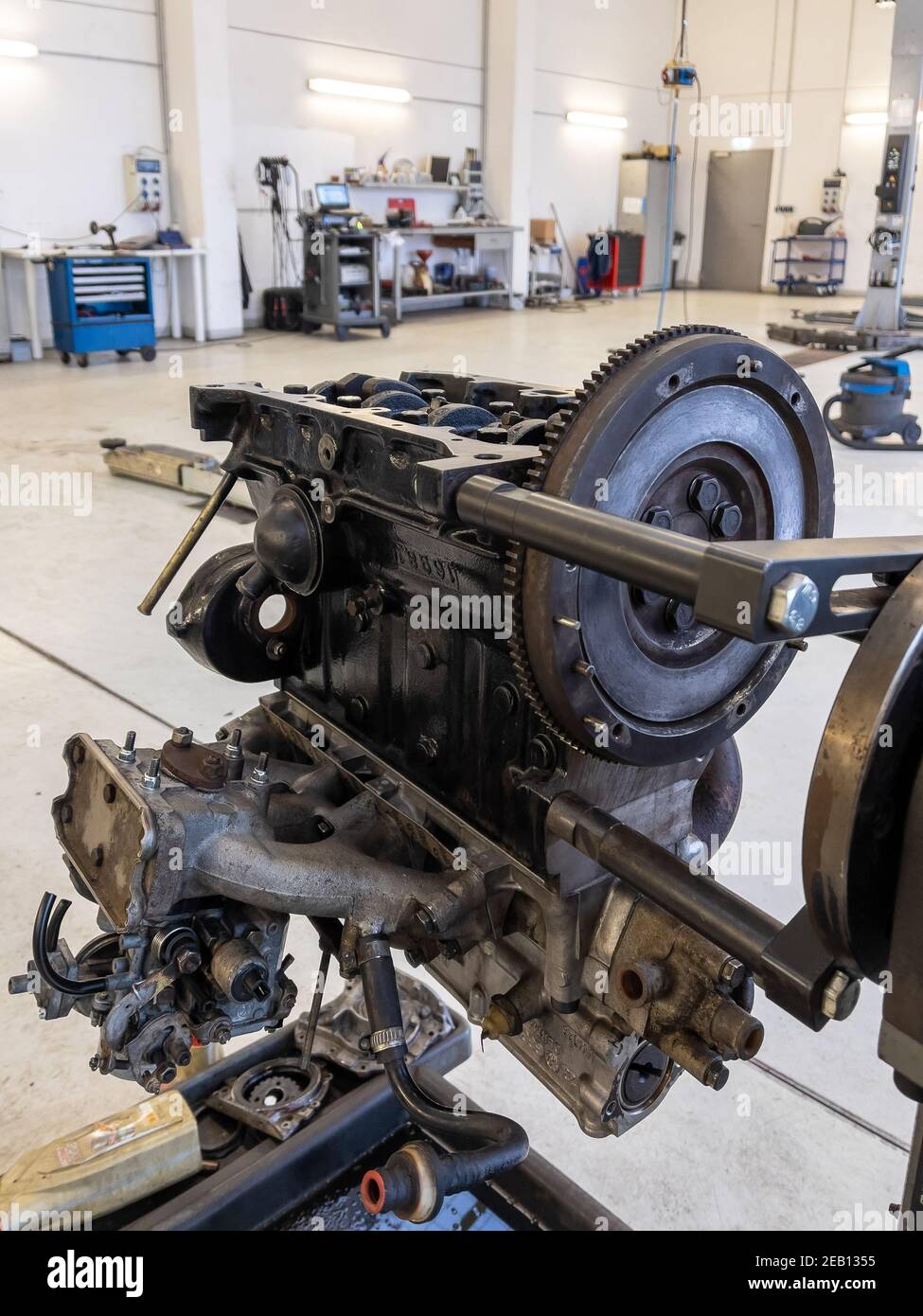 in a garage there is an opened engine block of a car Stock Photo - Alamy