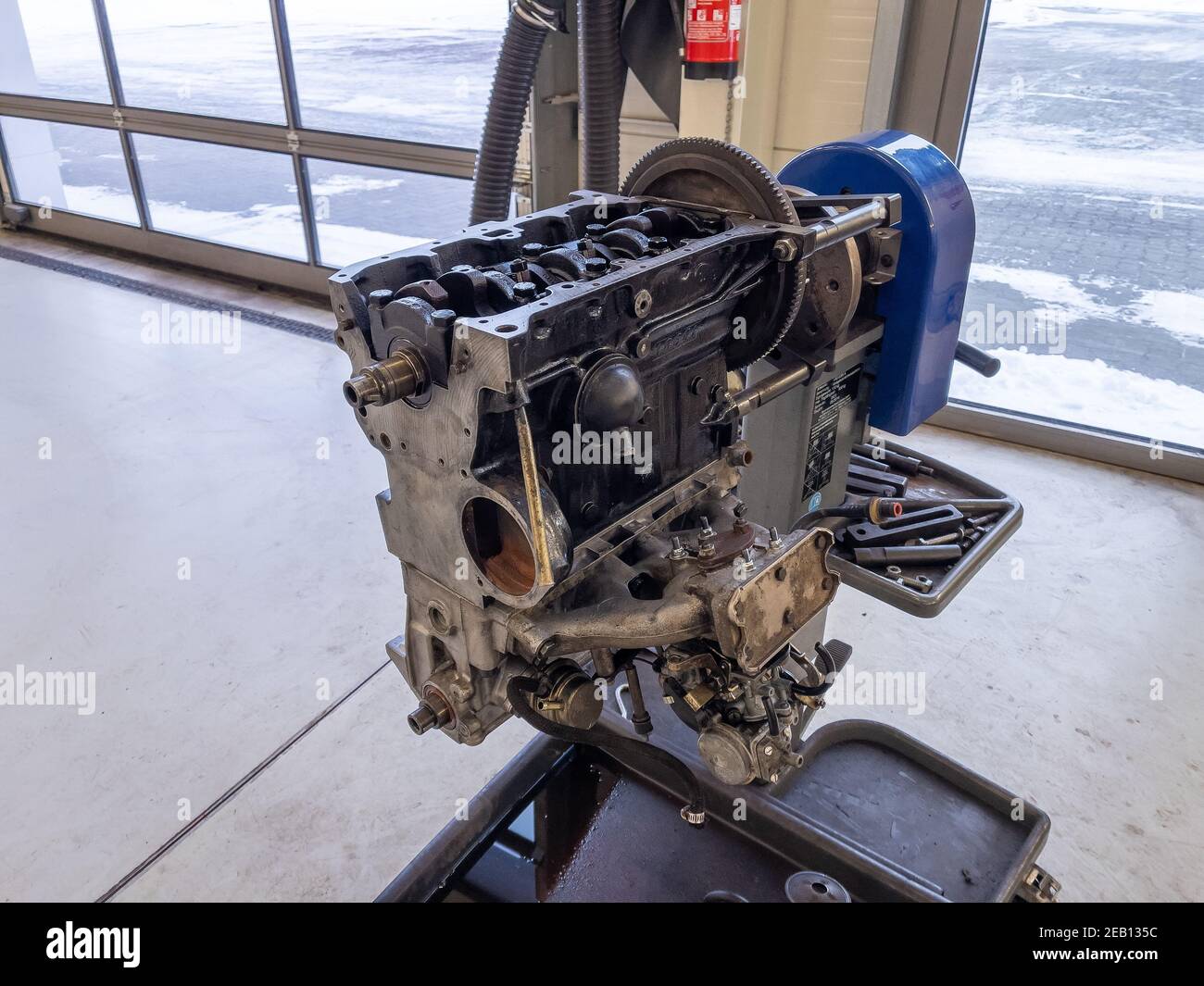 in a garage there is an opened engine block of a car Stock Photo - Alamy