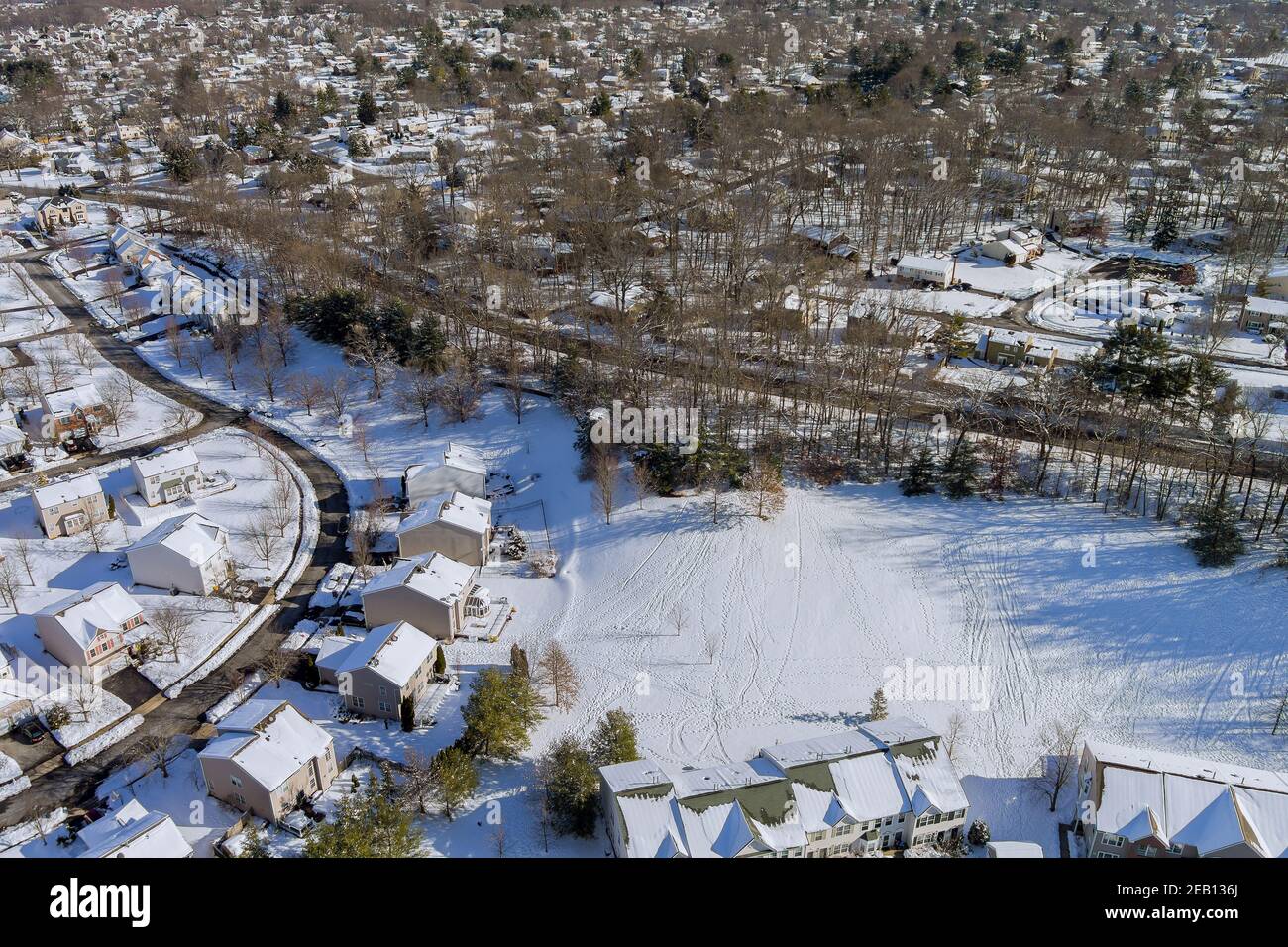 Aerial view of residential houses covered snow with snow on covered ...
