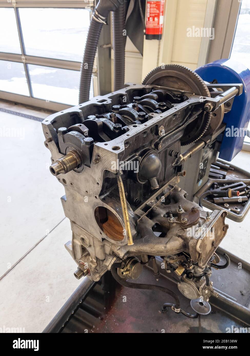 in a garage there is an opened engine block of a car Stock Photo - Alamy