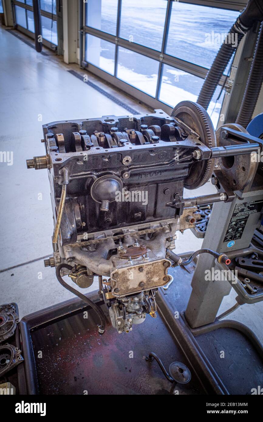 in a garage there is an opened engine block of a car Stock Photo - Alamy
