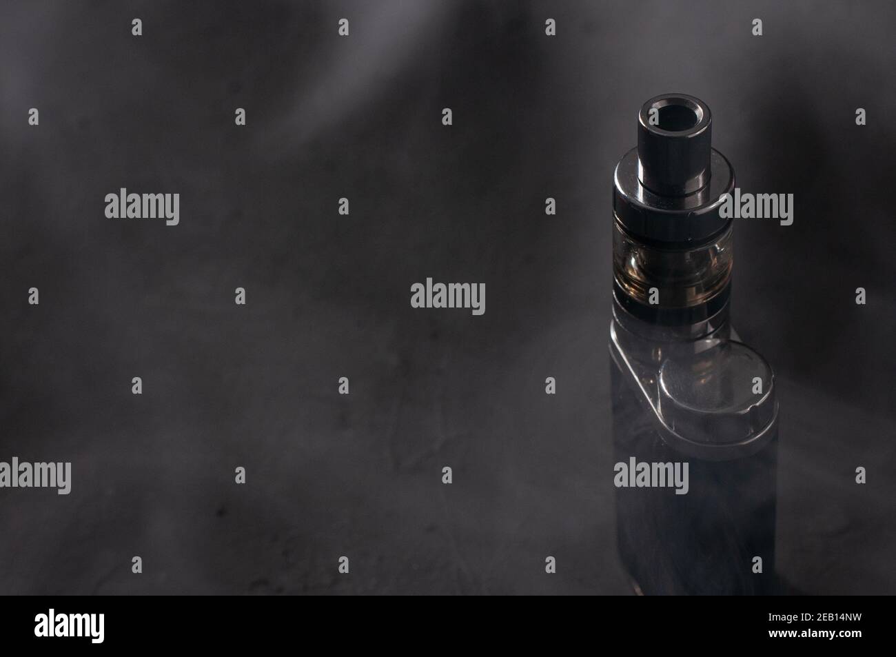 Vaping device in vapor smoke clouds, background with a copy space Stock ...