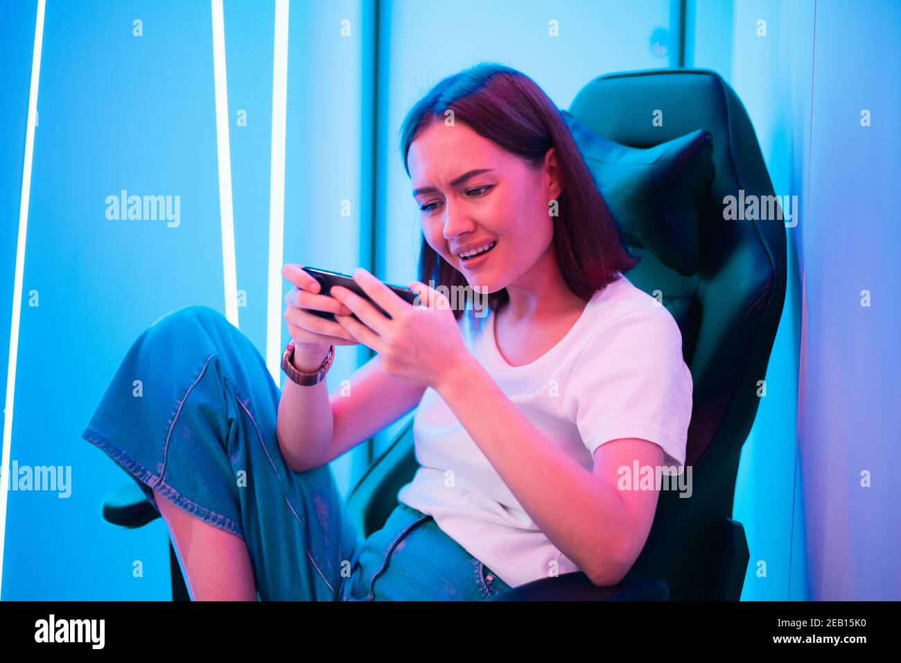 Young female professional cybersport gamer play mobile game by ...