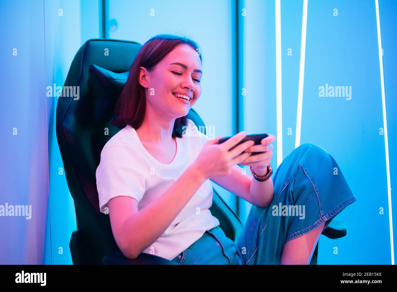 Young female professional cybersport gamer play mobile game by ...